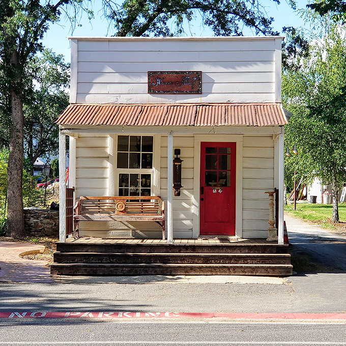 This tiny storefront with its welcoming red door and porch bench practically begs you to slow down and stay awhile.