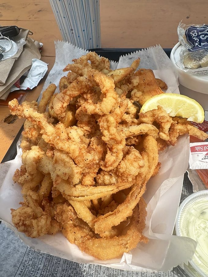 These fried clam strips aren't just food&mdash;they're crispy, golden tickets to seafood paradise. The paper wrapping barely contains their delicious rebellion.