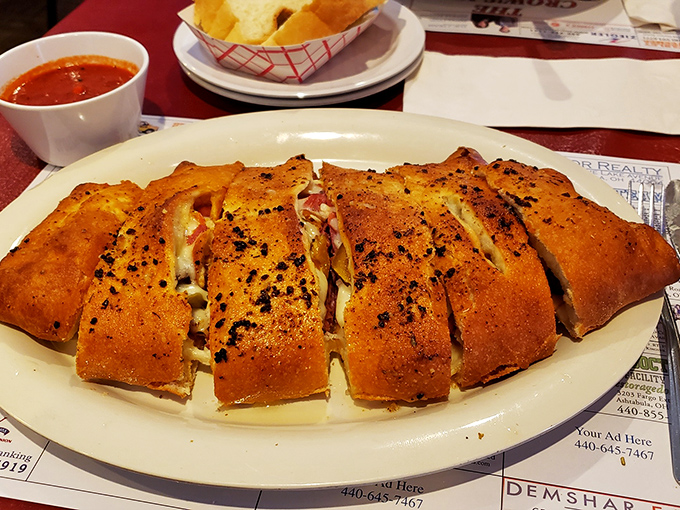 Stromboli sliced and ready, revealing its cheesy, meaty secrets like a delicious cross-section of happiness.
