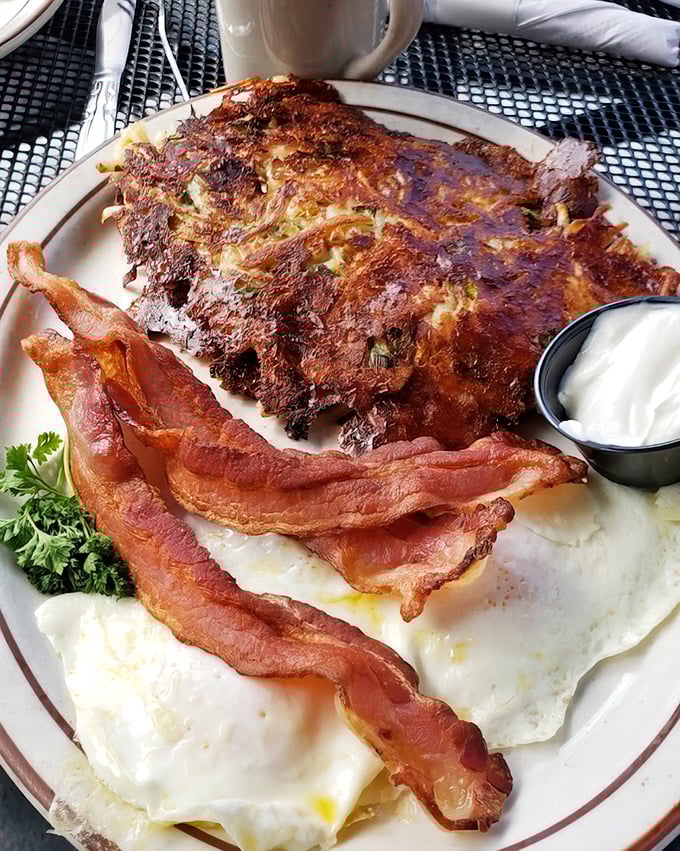 Breakfast architecture at its finest. These hash browns and eggs create the skyline of Flavortown, with bacon strips serving as delicious support beams. 