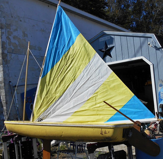 Nautical dreams for landlocked dreamers. This sunfish sailboat is just waiting for someone to rescue it from dry dock retirement.