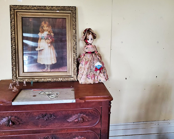 Childhood innocence preserved in dust. The antique doll and portrait create a tableau of abandoned youth that's both poignant and deeply unsettling.