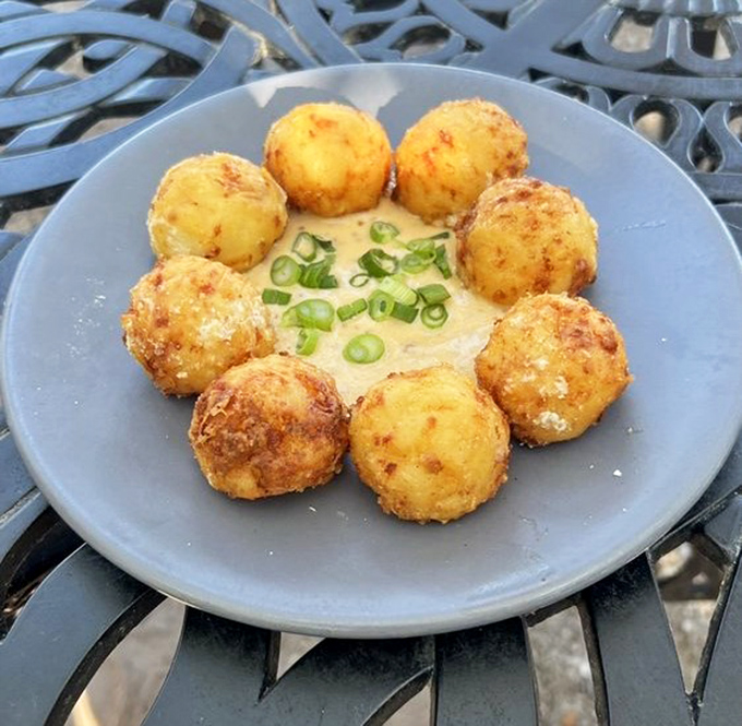 Golden-brown tater tots arranged like a sunburst around creamy dipping sauce &ndash; childhood comfort food that grew up and got sophisticated.