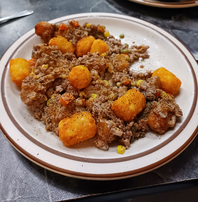 Tater tot hotdish: Minnesota's gift to comfort food that crossed the border to warm North Dakota souls. Crispy tots meet savory goodness in perfect harmony.