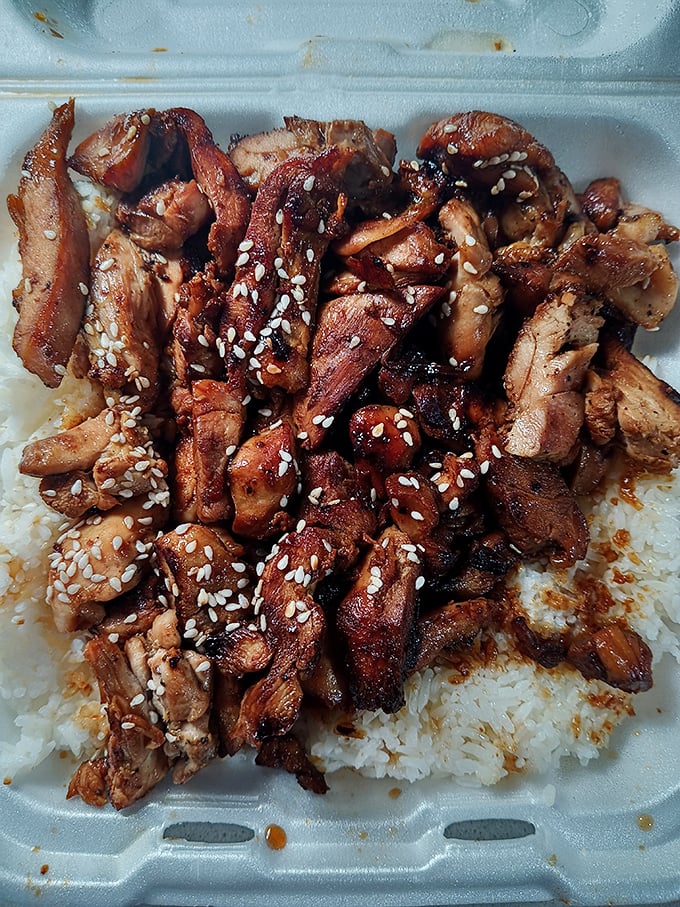 Teriyaki chicken over rice&mdash;where East meets West in a styrofoam container of cross-cultural culinary harmony.