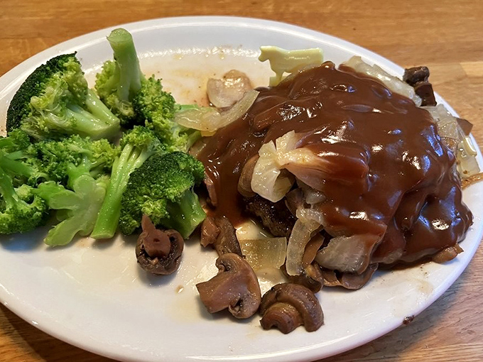 The Chopper steak swimming in rich gravy with mushrooms and onions&mdash;comfort food that hugs you from the inside out.