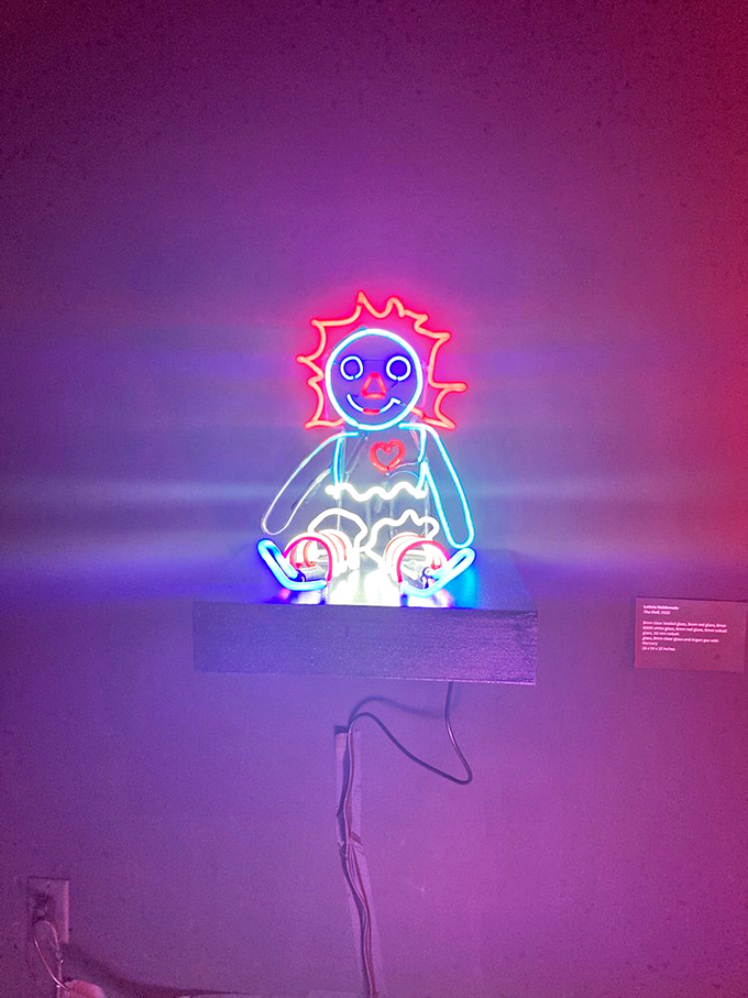 This neon doll radiates both childlike wonder and "definitely don't turn off the lights" vibes&mdash;a perfect balance of nostalgia and mild unease.