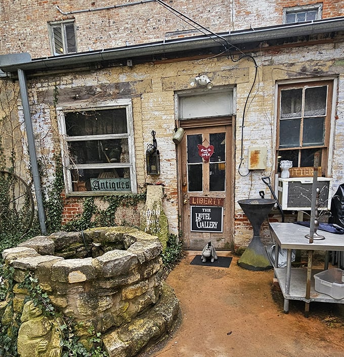 History whispers from every weathered brick at The Hotel Gallery, where that stone well could tell stories from centuries past.