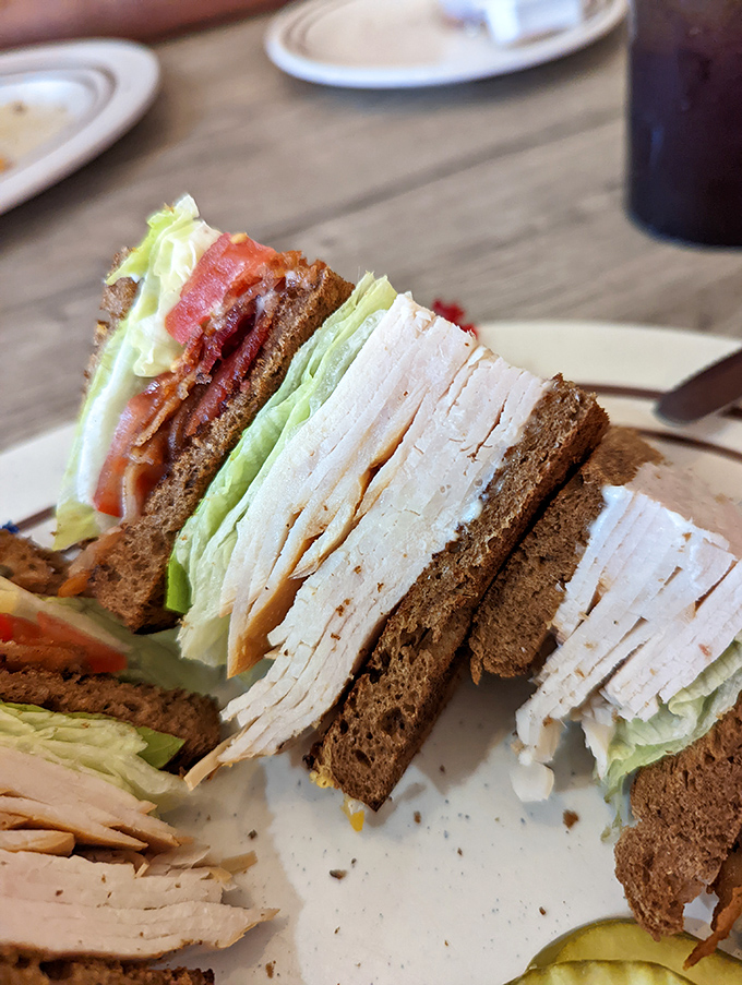 This club sandwich isn't playing around&mdash;layers upon layers of turkey and bacon creating the skyscraper of lunch architecture.