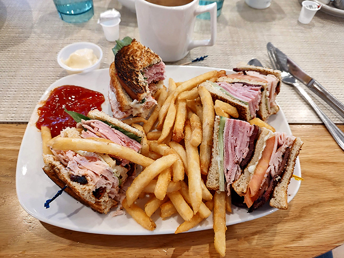 The club sandwich: three stories of deli perfection with crispy fries standing guard. Lunch has officially found its champion.