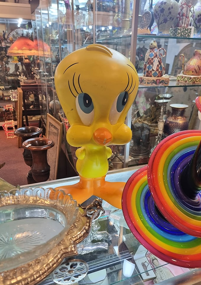 Tweety Bird standing guard over rainbow glass – because even cartoon birds appreciate good taste.