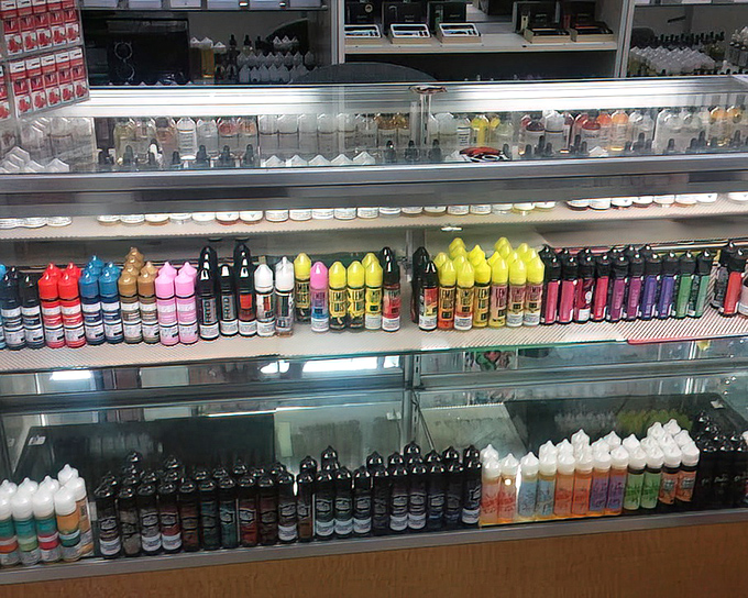 A colorful array of vaping supplies that would make a rainbow jealous. More flavors and options than an indecisive ice cream enthusiast could handle.