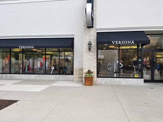 Versona's elegant storefront promises affordable luxury behind those gleaming windows. The sophisticated awnings practically whisper, "Your credit card won't hate you for this."