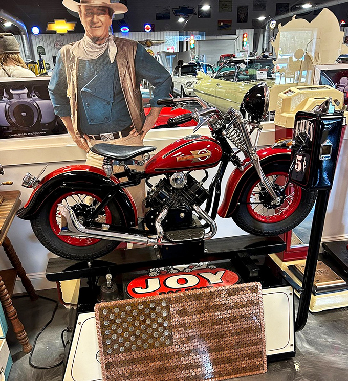 Even John Wayne seems impressed by this vintage Harley. Two American icons sharing space in a corner of motorized nostalgia.