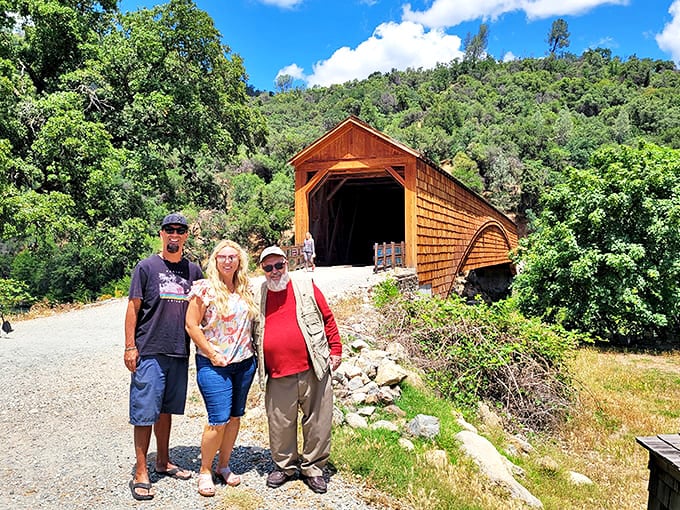 Three happy visitors pose with their prize discovery - proof that California's historical treasures create memories more valuable than any gold rush fortune.