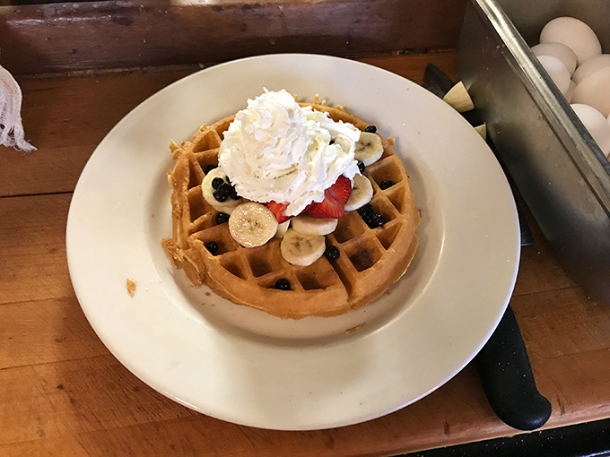 A waffle that's dressed for success with fresh fruit and whipped cream. The perfect canvas for maple syrup rivers and breakfast happiness.