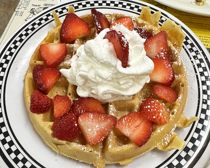 Golden waffles crowned with fresh strawberries and whipped cream&mdash;the breakfast equivalent of winning the lottery while finding an extra fry in your order.