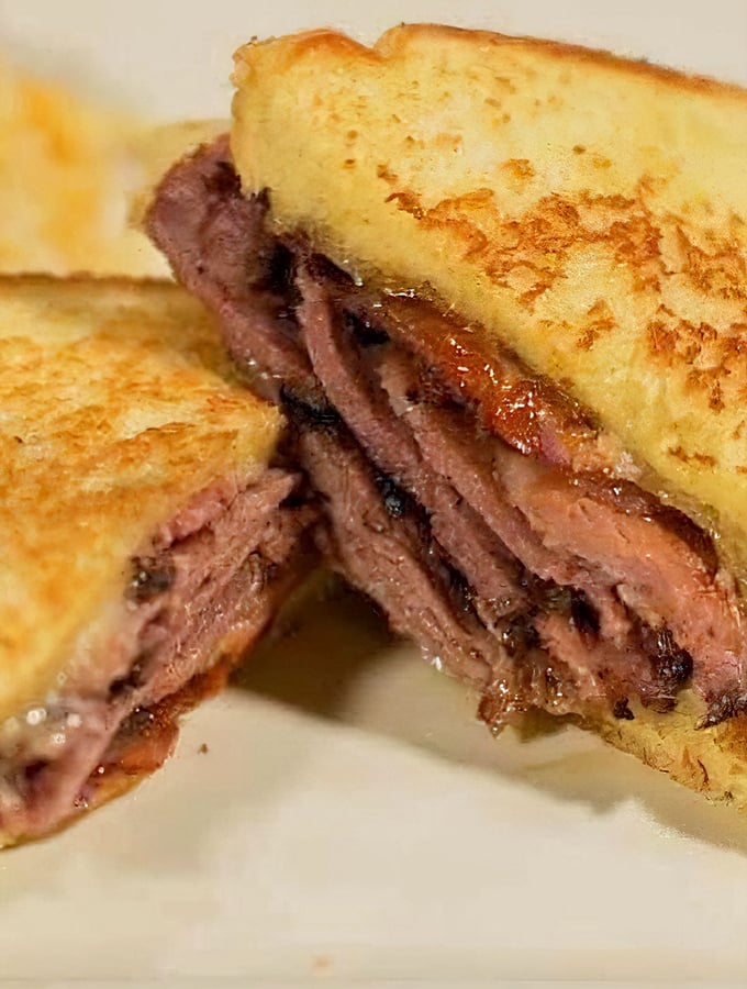 Behold the brisket sandwich that renders conversation impossible. Those perfectly toasted slices barely containing that glorious meat deserve your full attention.