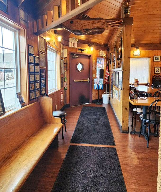 The waiting area's wooden warmth and nautical touches make even standing in line part of the experience. That porthole door is pure maritime magic.