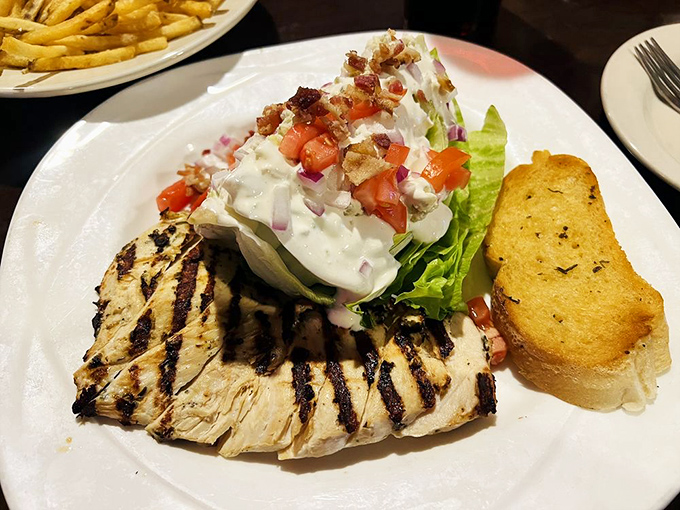 The wedge salad stands tall and proud, like it knows it's the healthiest decision you'll make today. Those bacon bits are not apologizing.
