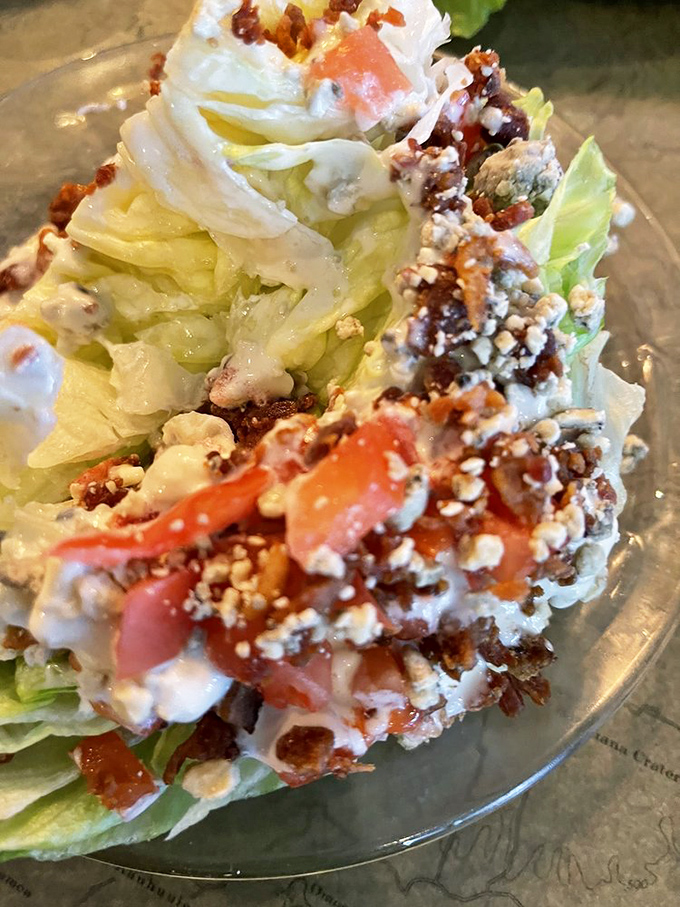 This wedge salad gets the royal treatment with blue cheese crumbles and bacon bits cascading down like delicious confetti at a lettuce parade.