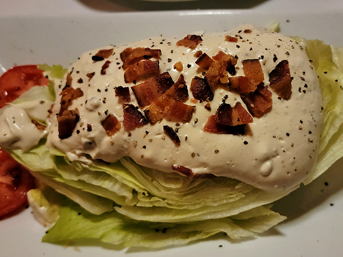 The wedge salad&mdash;a steakhouse classic that somehow makes iceberg lettuce exciting. Those bacon bits aren't just toppings; they're little flavor grenades.