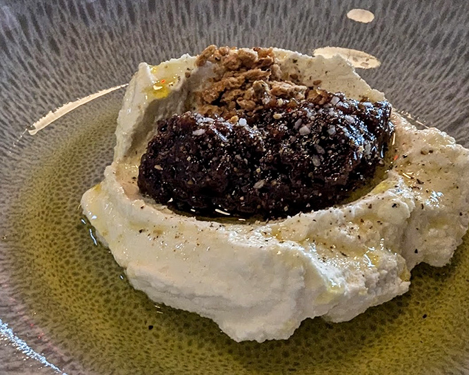 This isn't just dessert, it's an edible sculpture&mdash;whipped ricotta cradling dark, rich morsels that demand to be savored slowly.