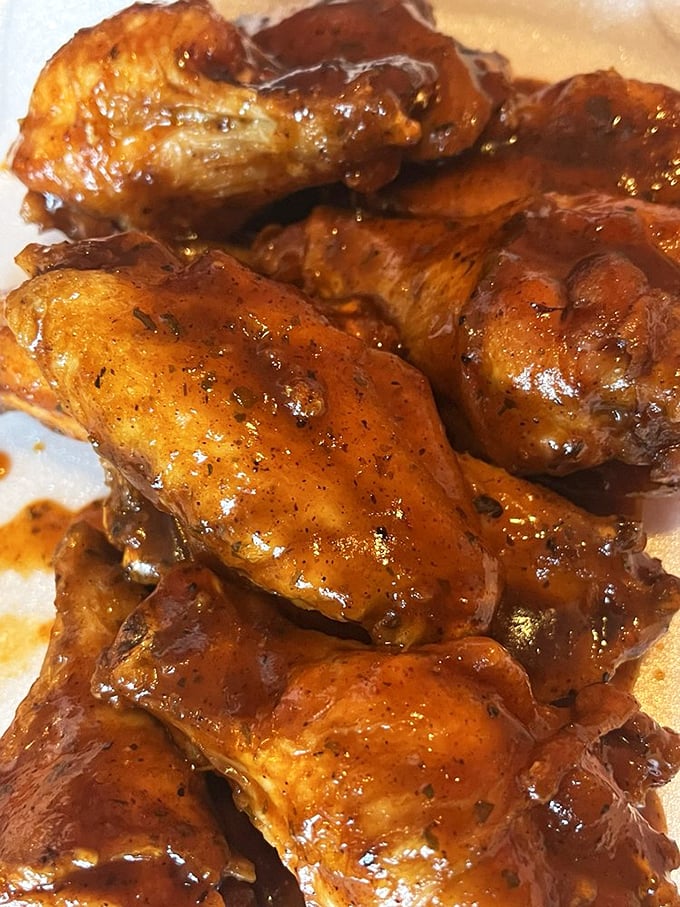Wings glistening with sauce like they've been polished. The kind that make you forget napkins exist until it's far too late.