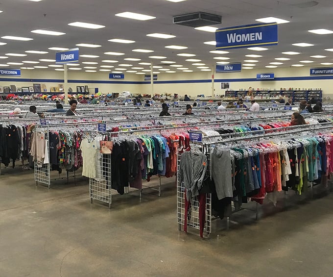 The clothing forest, where color-coded racks create paths through fashion history. Someone's "what was I thinking?" becomes your "where have you been all my life?"