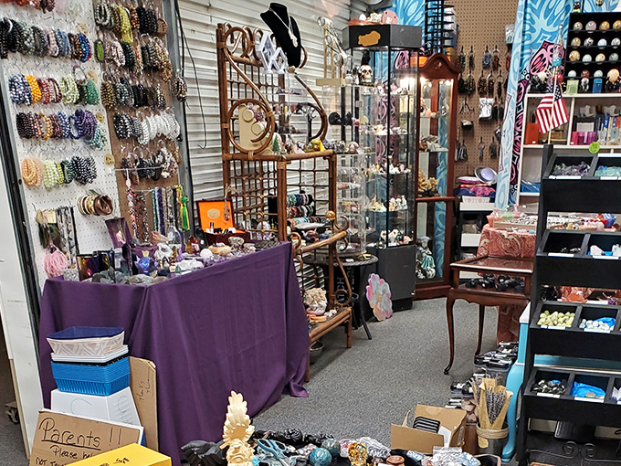 A jewelry vendor's carefully curated collection. Someone's next favorite necklace is hiding in this purple-draped treasure trove.