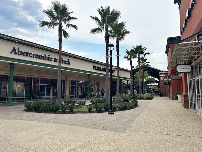 Palm trees and coastal architecture create the illusion that spending money is actually a tropical vacation experience.