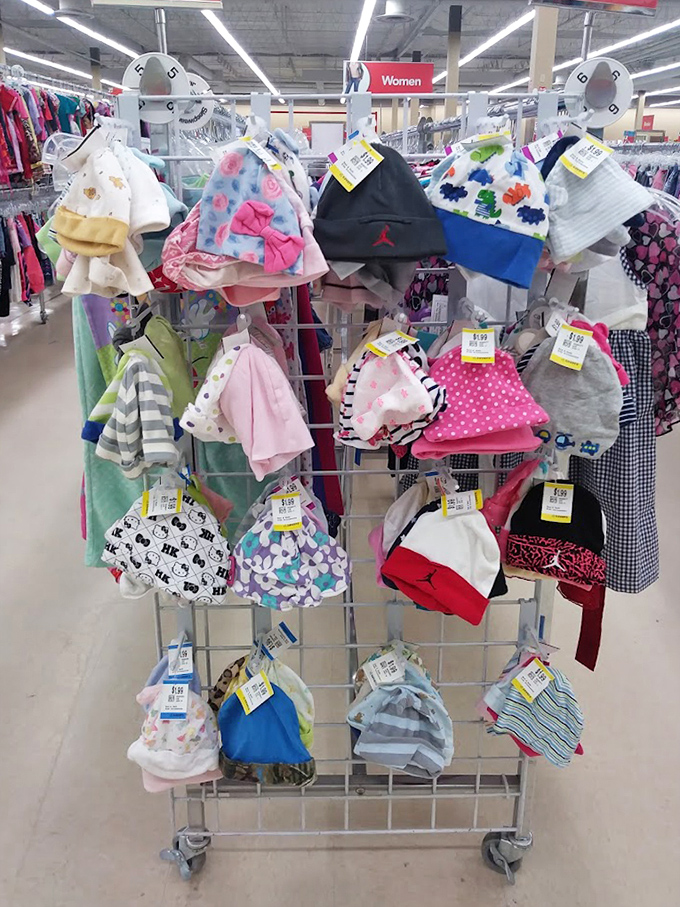 Baby hats organized like a tiny millinery shop, because even the smallest heads deserve secondhand style and savings.