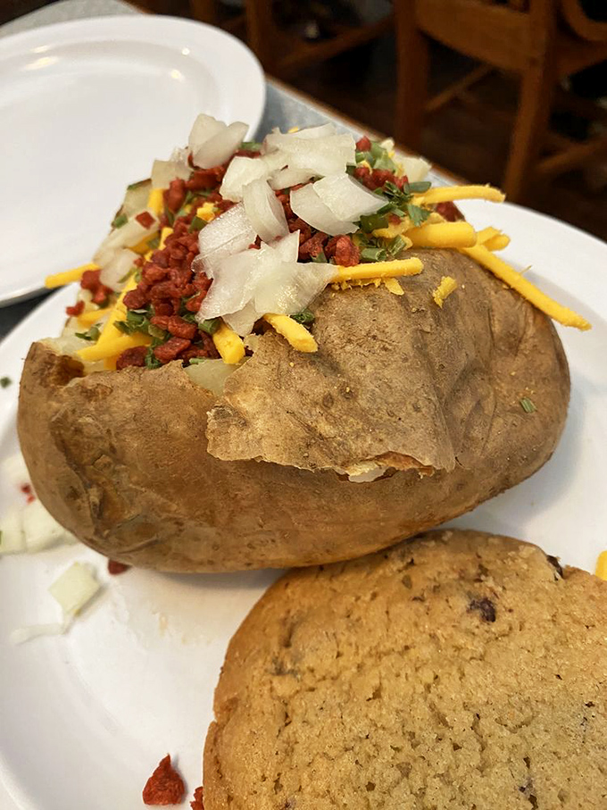 This loaded baked potato could be a meal all by itself. It's wearing all its toppings like medals of honor.