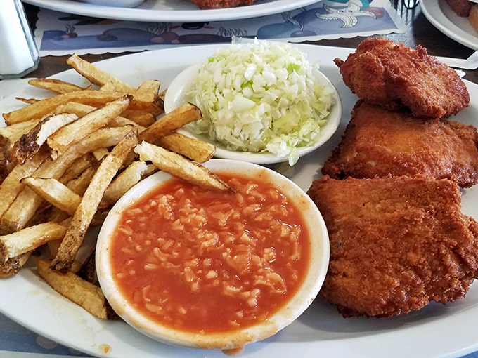 A complete Barberton feast: crispy chicken, tangy hot rice, creamy slaw, and fries that make you wonder why you'd ever waste calories on fast food.