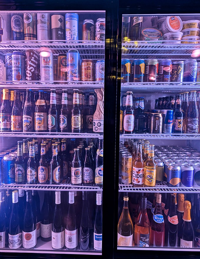 The refrigerator case isn't just storing beer &ndash; it's displaying a United Nations of brewing traditions that would make any diplomat thirsty.