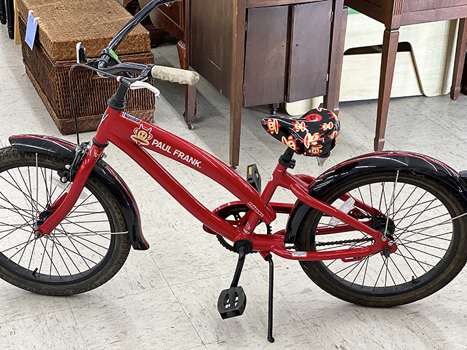This cherry-red Paul Frank bicycle isn't just transportation; it's childhood nostalgia with wheels, ready for its next neighborhood adventure.