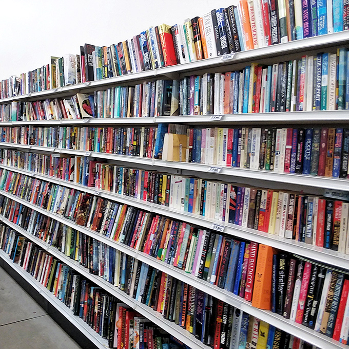 A library without late fees, where dog-eared paperbacks and hardcover treasures await their next reader's gentle touch.