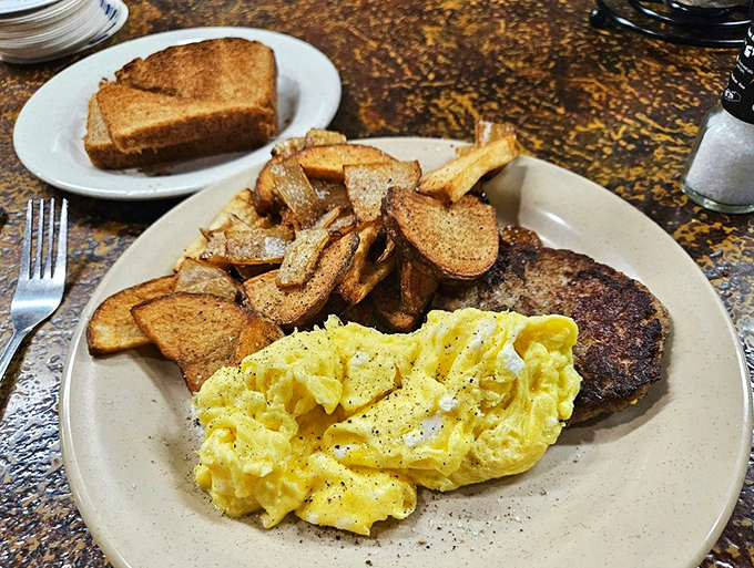 Breakfast of champions: perfectly scrambled eggs, home fries with personality, and toast that knows its supporting role. Morning fuel doesn't get more honest than this.