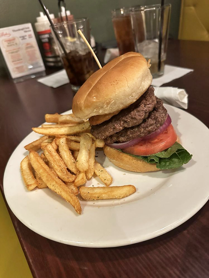 A burger that stands tall and proud, like it knows something you don't. Those seasoned fries are no mere sidekick.