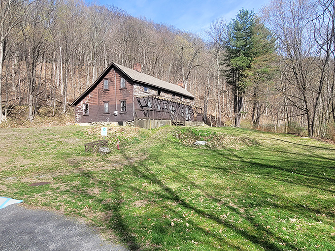 This rustic Berkshire cabin seems to whisper stories of simpler times, nestled against a backdrop of bare spring trees awaiting their summer wardrobe.