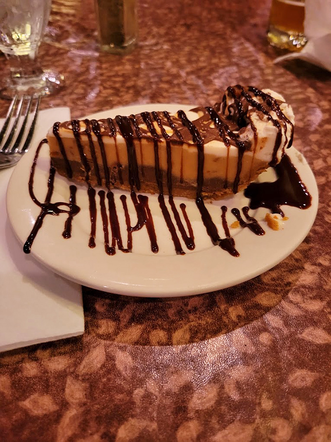 Cheesecake drizzled with chocolate that makes you wonder why people bother with birthday cakes. This slice demands a moment of respectful silence.