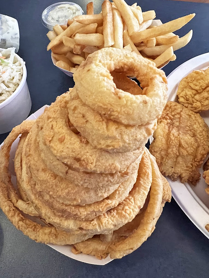 The tower of onion rings that says, "Yes, we take our side dishes as seriously as our seafood." A golden-brown monument to crunch.