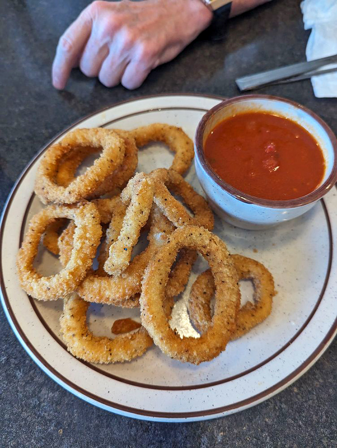 Golden onion rings with marinara&mdash;the perfect starter that makes you wonder why we don't begin every meal this way.