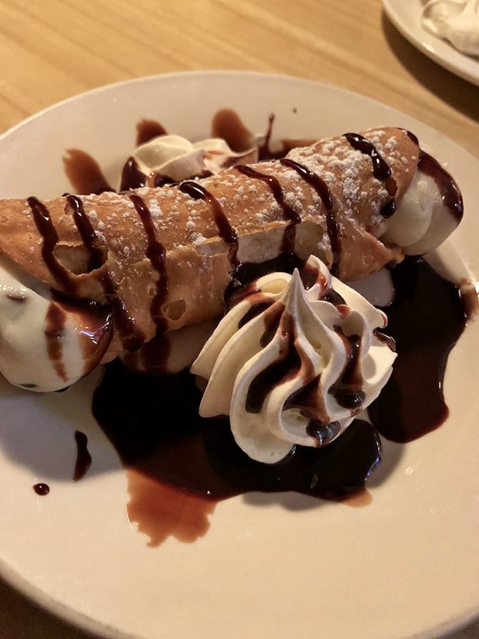 A cannoli that would make any Sicilian grandmother nod in approval—crisp shell, creamy filling, and that perfect chocolate drizzle.