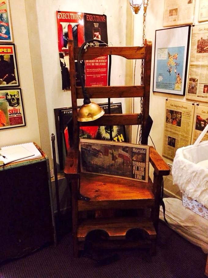 A replica electric chair sits ominously in one corner, surrounded by newspaper clippings documenting its grim historical use.
