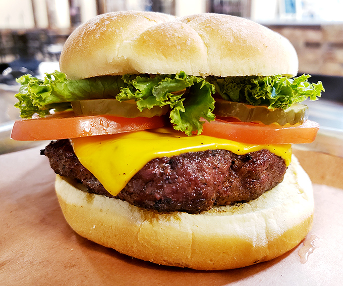 This isn't just a cheeseburger; it's architecture. The structural integrity alone deserves an engineering award, not to mention the flavor payload.