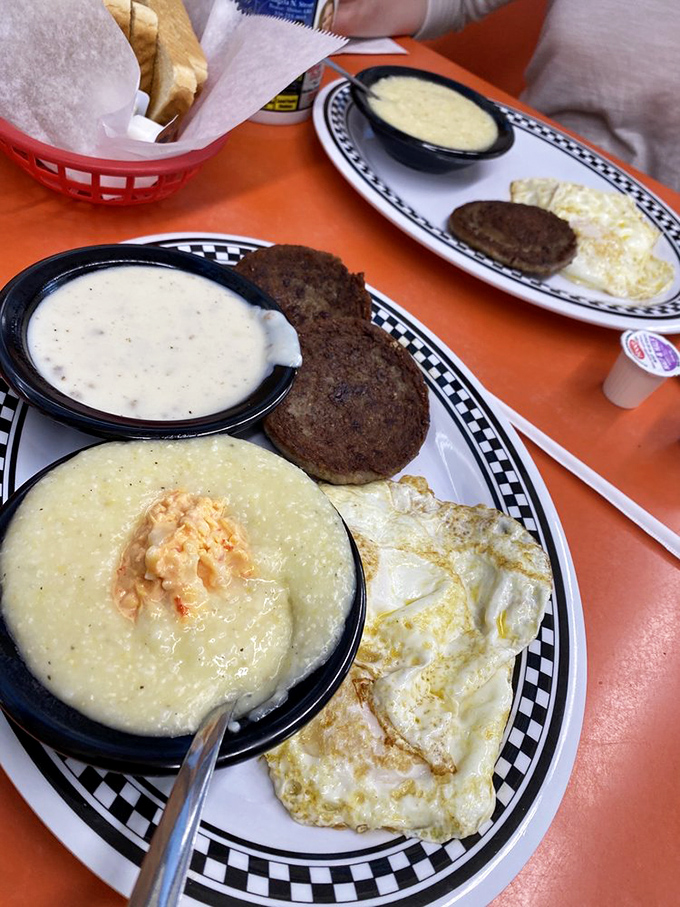 Grits, eggs, and sausage patties—the holy trinity of Southern breakfast that turns morning grumps into grateful humans one bite at a time.