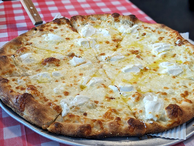 The white pizza that proves sometimes less is magnificently more. Creamy cheese islands on a sea of garlic-infused olive oil&mdash;simplicity at its finest.