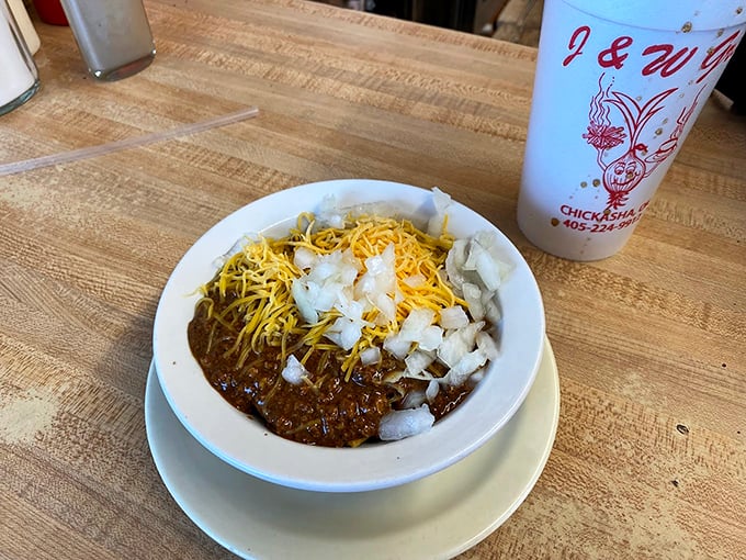 A bowl of J&W's homemade chili topped with cheese and onions&mdash;proof that sometimes the most unassuming dishes deliver the most profound satisfaction.