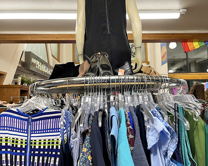 A mannequin oversees a rainbow of shirts while hangers wait expectantly. Fashion doesn't die here&mdash;it just finds a new runway.